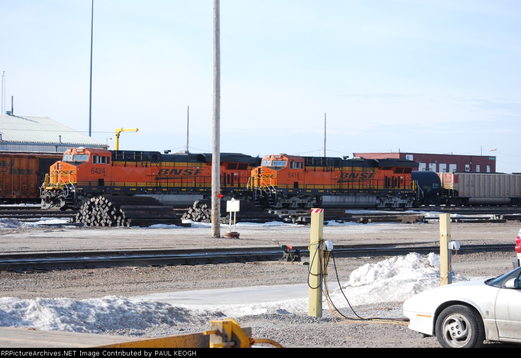 Distance shot of BNSF 6424 and BNSF 6418 as they wait in the middle of the BNSF Lincoln yard.